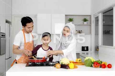 Muslim family cooking together in the kitchen Stock Image #78729276