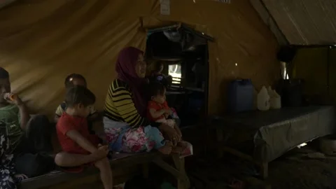 A Muslim family living in a tent shelter | Stock Video | Pond5