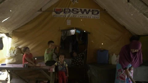 A Muslim family living in a tent shelter | Stock Video | Pond5