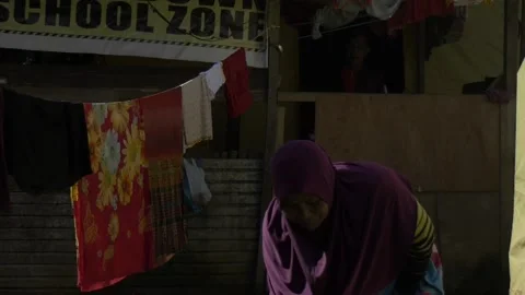 A Muslim family living in a tent shelter | Stock Video | Pond5