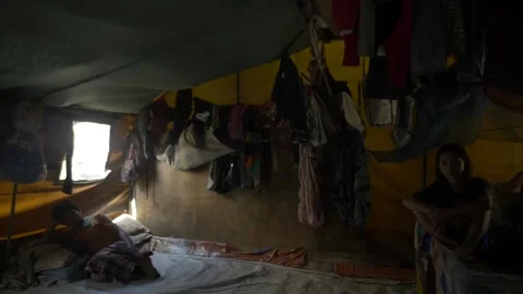 A Muslim family living in a tent shelter | Stock Video | Pond5