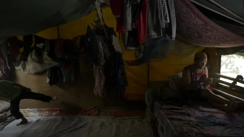 A Muslim family living in a tent shelter | Stock Video | Pond5