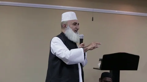 Muslim Imam is speaking to a crowd at a ... | Stock Video | Pond5