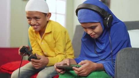 Muslim kid boy playing game and kid girl... | Stock Video | Pond5