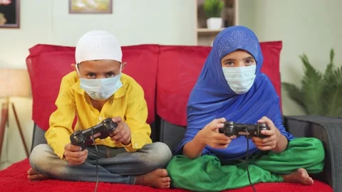 Muslim kids playing Video games seriousl... | Stock Video | Pond5