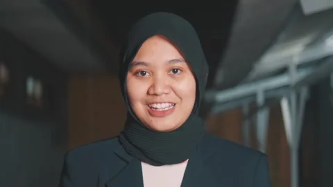 a muslim reporter in a headscarf and a b... | Stock Video | Pond5