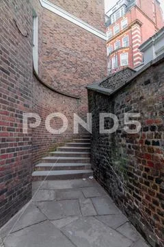 Photograph: A mysterious and hidden old back alley with staircase in ...