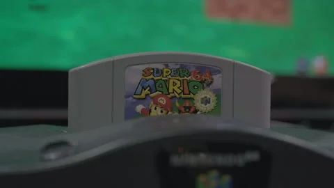 N64 with Mario 64 played in background 4... | Stock Video | Pond5