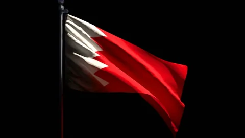 The national flag of Bahrain is flying i... | Stock Video | Pond5