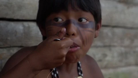 Native Brazilian child eating food at Tu... | Stock Video | Pond5