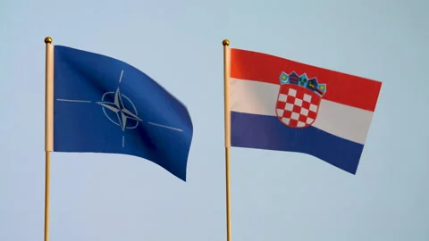 NATO and Croatia flags flying against wh... | Stock Video | Pond5