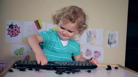 Naughty little child destroy computer ke... | Stock Video | Pond5
