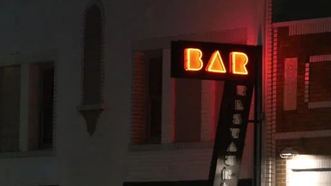A neon bar sign flashing at night | Stock Video | Pond5