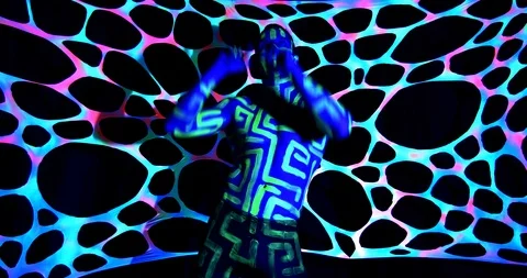Neon body art, a man is glowing in the d... | Stock Video | Pond5