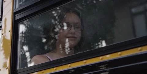 Nerdy girl looking sad in bus window fro... | Stock Video | Pond5