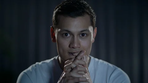 Nervous man sitting at home biting his n... | Stock Video | Pond5