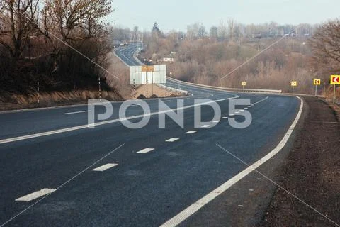 New asphalt road with markings and road signs in the sun's rays Stock ...