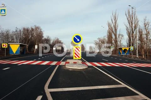 Photograph: New asphalt road with markings and road signs in the sun's ...