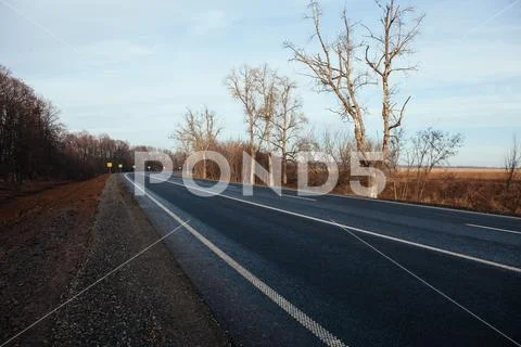 New asphalt road with markings and road signs in the sun's rays ~ Hi ...