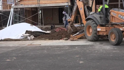 New Home Building, backhoe moving dirt f... | Stock Video | Pond5