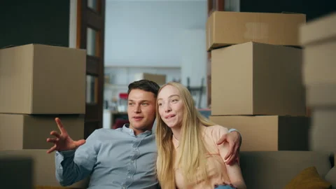 New owners sit down on couch between car... | Stock Video | Pond5