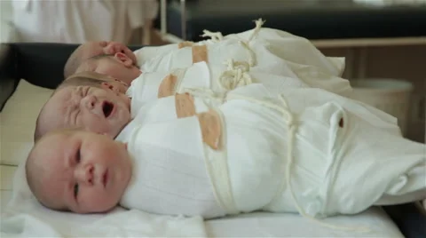 Newborn babies lying on the table at mat... | Stock Video | Pond5