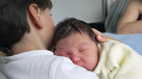 Newborn baby being cradled in an older s... | Stock Video | Pond5