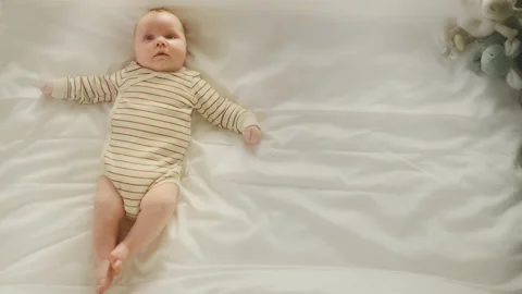Newborn Baby Lying on a Bed | Stock Video | Pond5