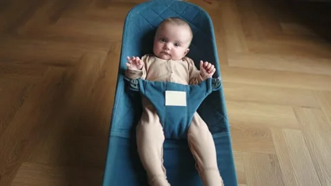 newborn baby in a rocking chair. happy f... | Stock Video | Pond5