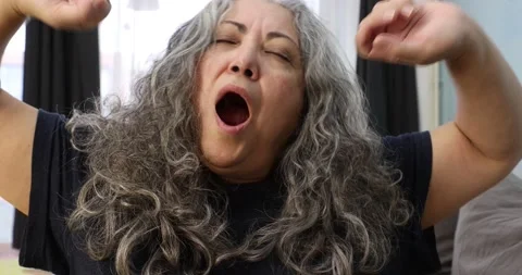 Newly woken up older woman's face yawnin... | Stock Video | Pond5