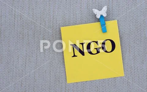 NGO - word on yellow paper with clothespin on gray background Stock ...