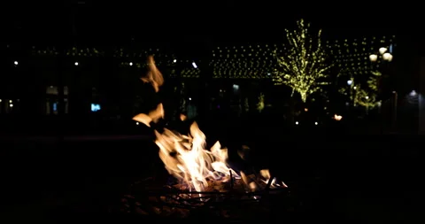 Night fire flames holiday lights in back... | Stock Video | Pond5