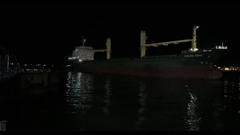 Night mooring of the cargo ship to the q... | Stock Video | Pond5