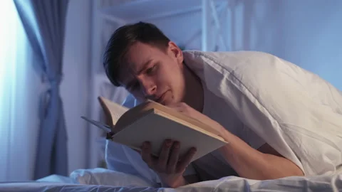 night reading guy falling asleep with bo... | Stock Video | Pond5
