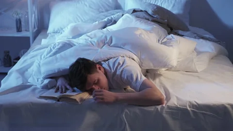 night relaxing reading man sleeping with... | Stock Video | Pond5