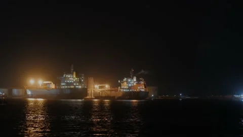 Night sighting of cargo ships docked at ... | Stock Video | Pond5