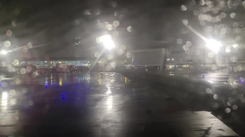 Nighttime Plane on Runway with Rain Drop... | Stock Video | Pond5