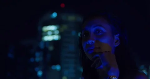 A nighttime rooftop scene features a you... | Stock Video | Pond5