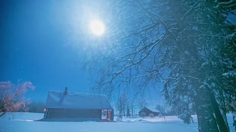Nighttime winter scene of cabins in snow... | Stock Video | Pond5