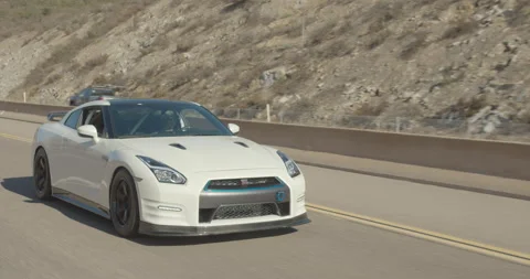 Nissan GTR Speeds Past Camera | Stock Video | Pond5