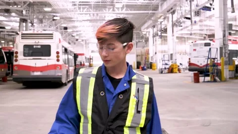 Non binary worker walking in bus mainten... | Stock Video | Pond5