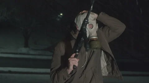 nuclear winter gas mask guy with gun | Stock Video | Pond5