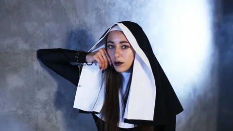 Nun shows the middle finger of the hand | Stock Video | Pond5