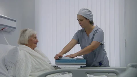 Nurse opens lunch box with meal to femal... | Stock Video | Pond5