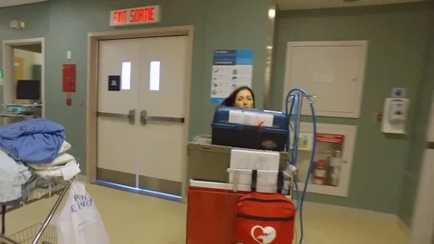 Nurse runs with a crash cart as a doctor... | Stock Video | Pond5