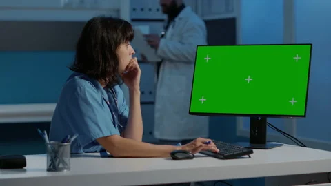 Nurse standing at desk looking at comput... | Stock Video | Pond5