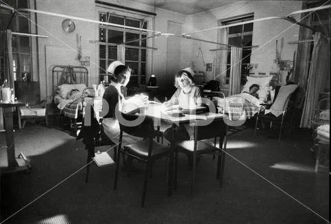 Nurses Carolina Amaba And Jane Parry In A Hospital Ward With Sleeping ...