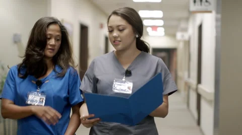 Nurses talking about file folder in hosp... | Stock Video | Pond5