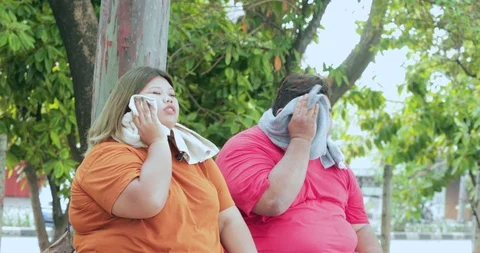 Obese couple wiping sweat while sitting ... | Stock Video | Pond5