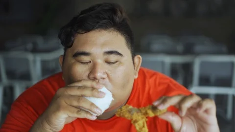 Obese man eating fried chicken and white... | Stock Video | Pond5